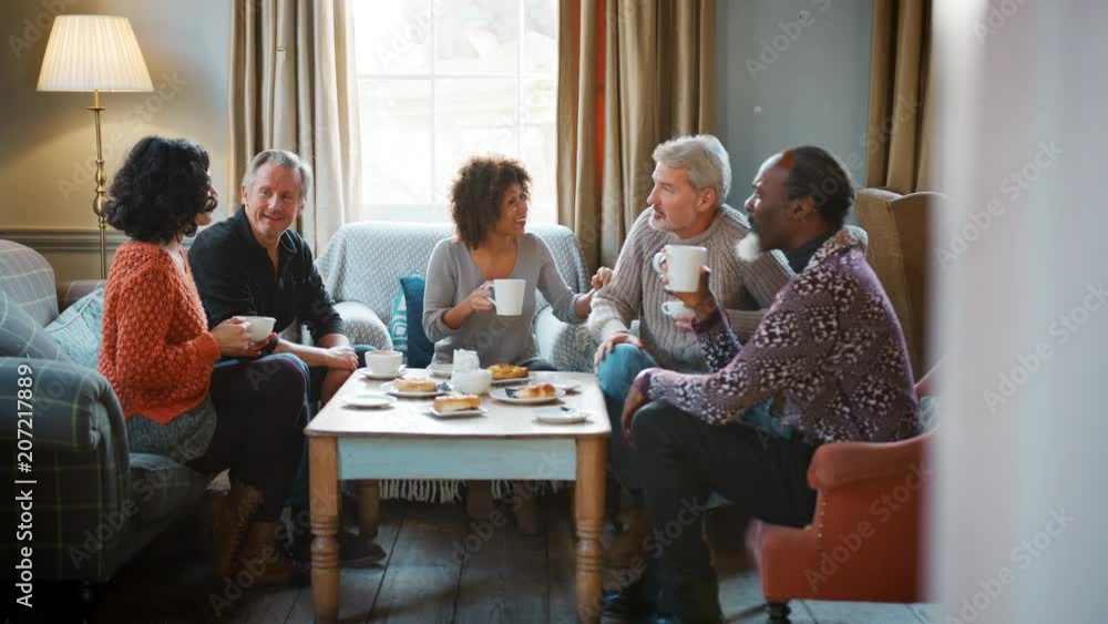 Group Of Middle Aged Friends Meeting Around Table In Coffee Shop Stock ...