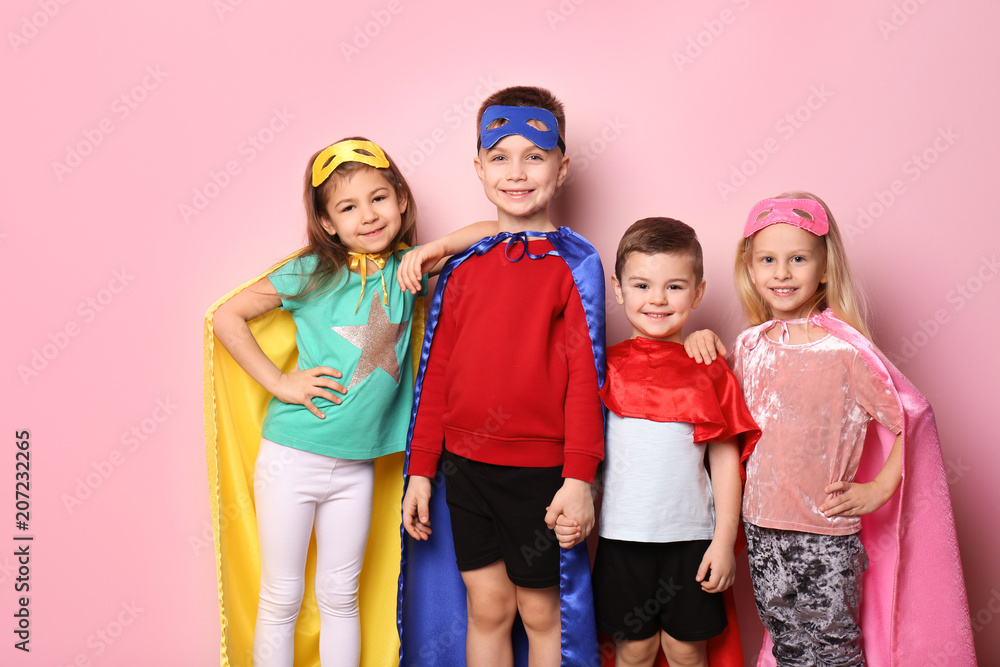 Cute children in superhero costumes on color background Stock Photo ...