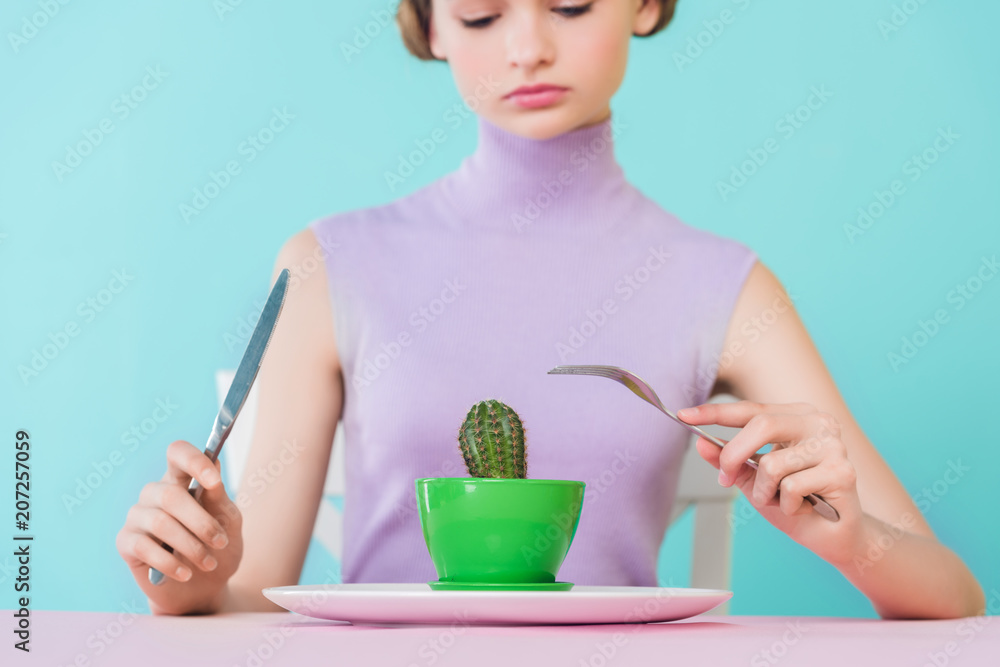 beautiful teen girl eating cactus with fork and knife, diet concept ...
