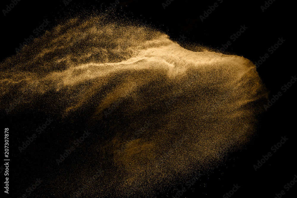 Golden sand explosion isolated on black background. Abstract sand cloud ...