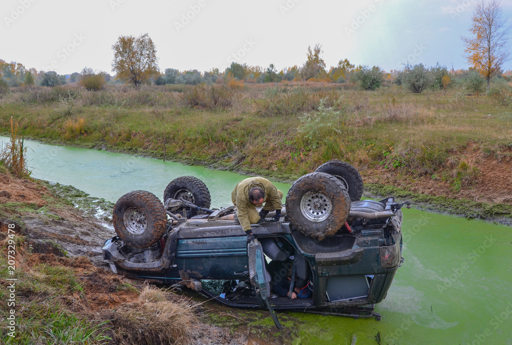Auto accident. Overturned off-road vehicle. Road accident. The car is ...