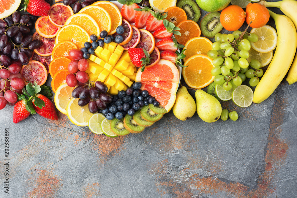 Healthy fruits background in rainbow colours oranges apples grapes ...