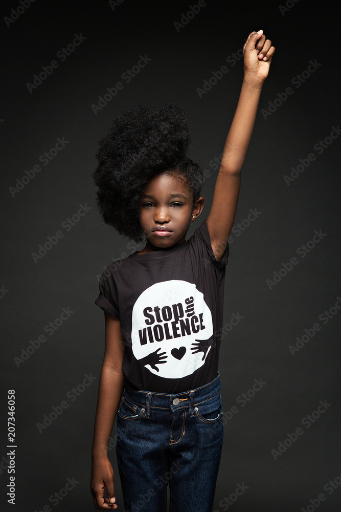 Portrait of girl standing against black background Stock Photo | Adobe ...
