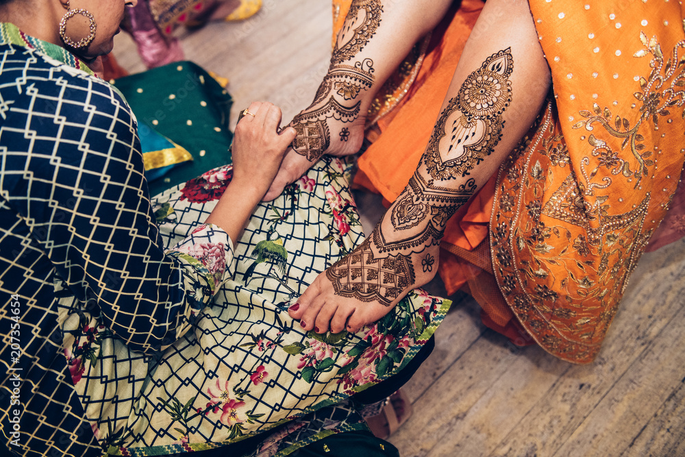 Process of applying traditional Mehndi henna on female leg. Close-up ...