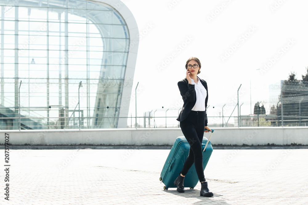 . Business woman at international airport moving to terminal gate for ...