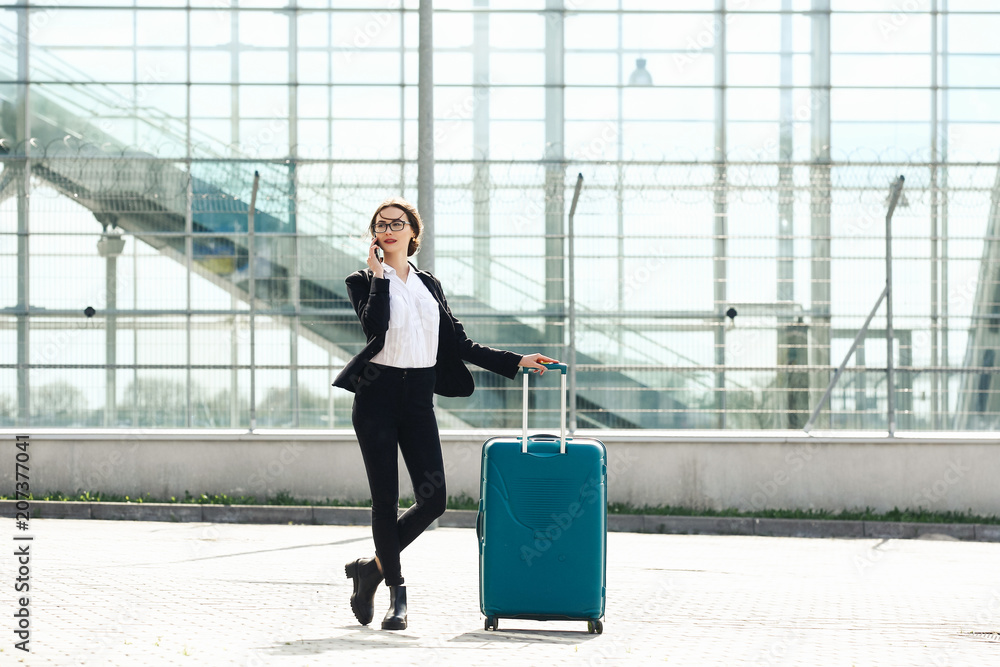 . Business woman at international airport moving to terminal gate for ...