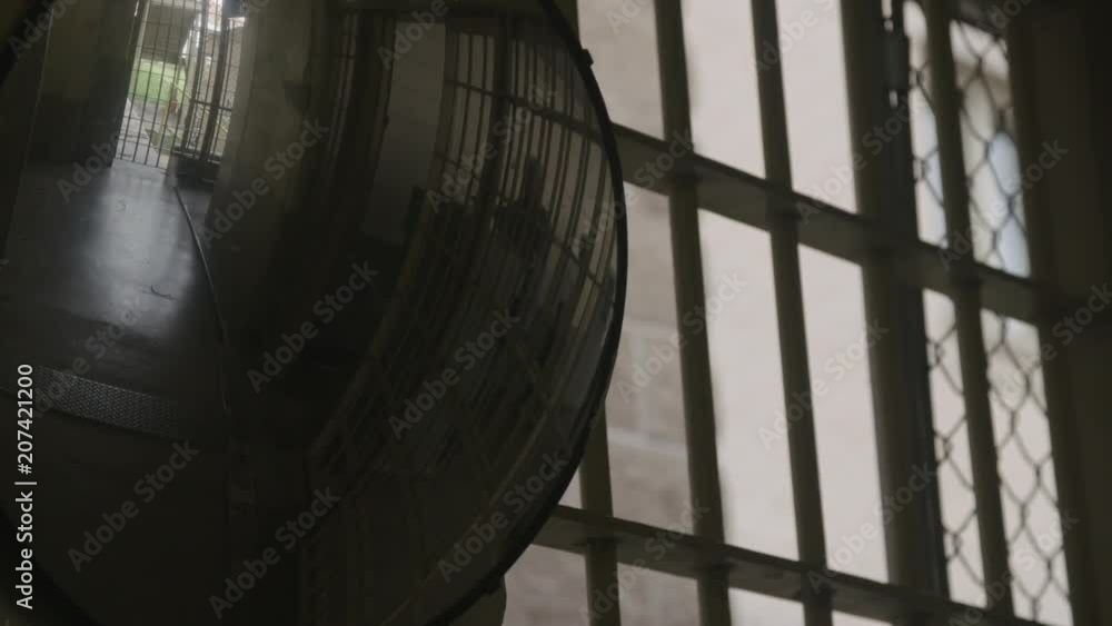 Security mirror of prison gate opening with prisoner and food cart ...
