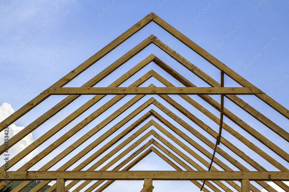 Close-up detail of wooden high steep roof framing under construction ...