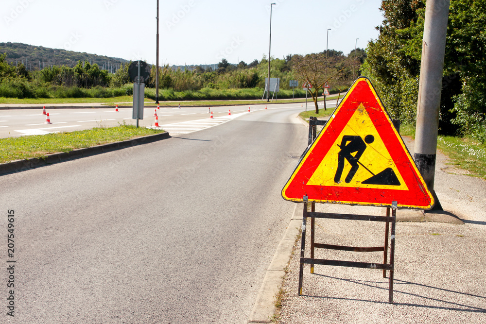 Road works sign for construction works in city street. Road under ...