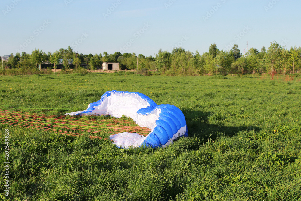 pilot newcomer paraglider is trained on the ground to lift up and hold ...