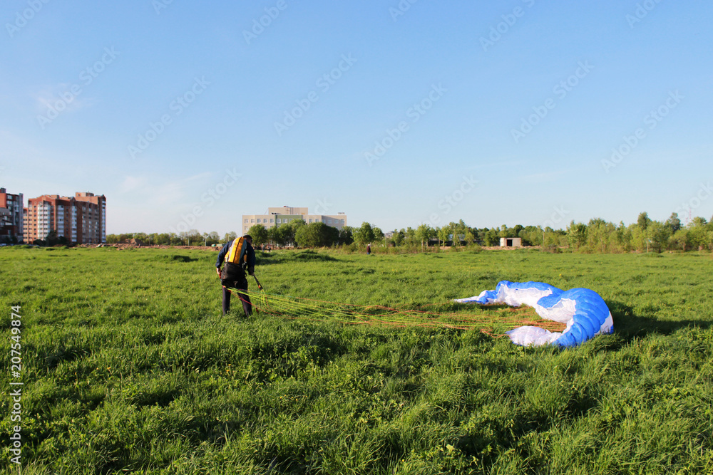 pilot newcomer paraglider is trained on the ground to lift up and hold ...