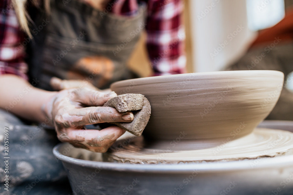 Female potter making clay pottery on a spin wheel. Stock Photo | Adobe ...