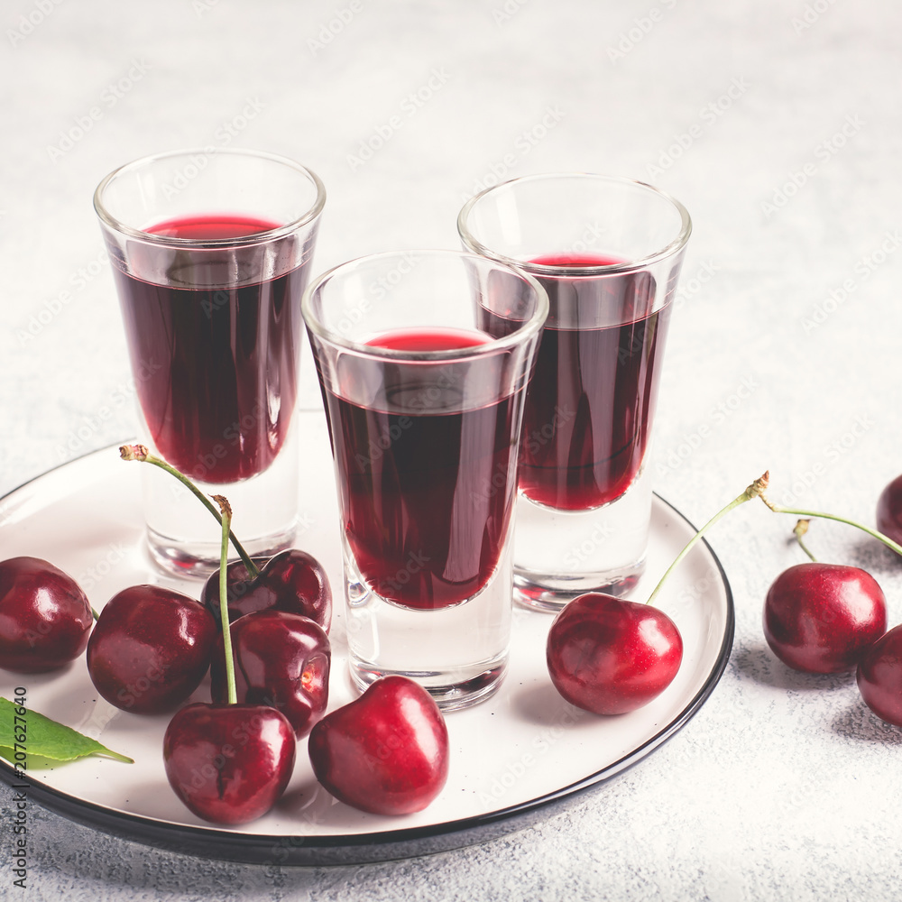 Cherry alcohol drink liquor or brandy on pink background Stock Photo ...