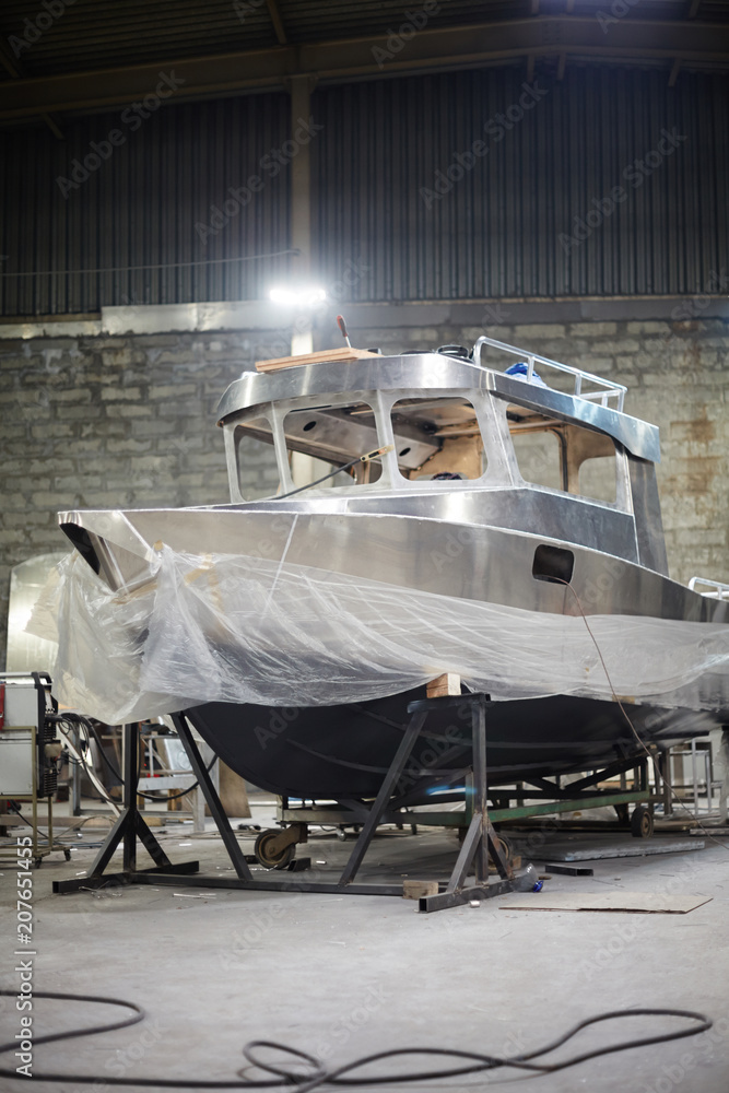 New empty metallic boat in hangar or shipyard built by modern engineers ...