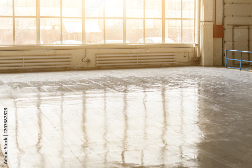 Industrial interior with wide floor to ceiling window. Factory building ...