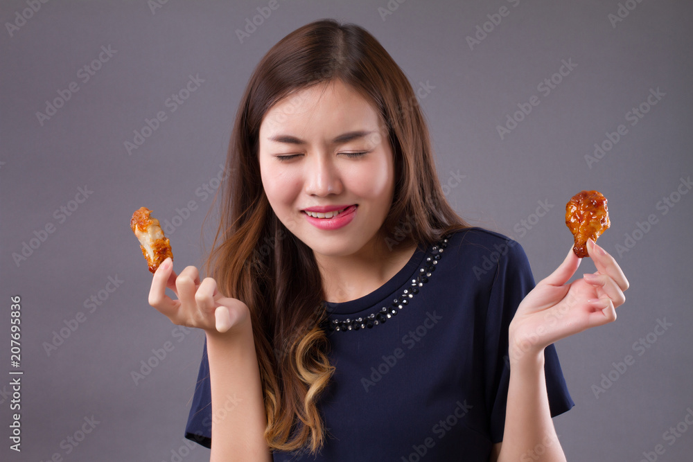 asian woman eating fried chicken; portrait of beautiful woman, happy ...