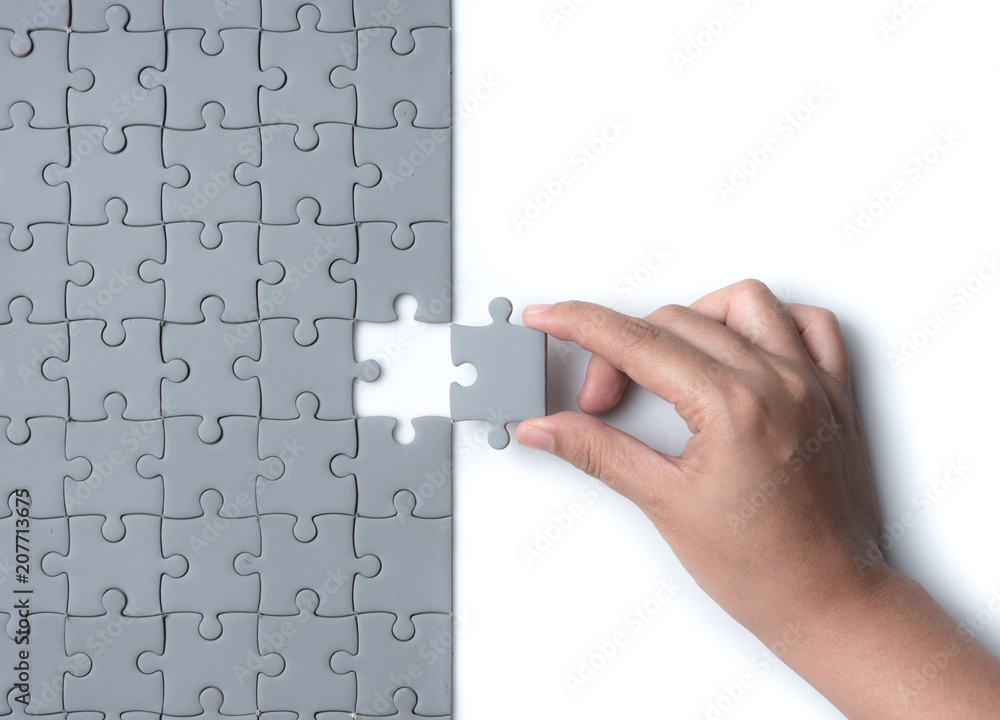 Hand put the last piece of jigsaw puzzle, success, teamwork and ...