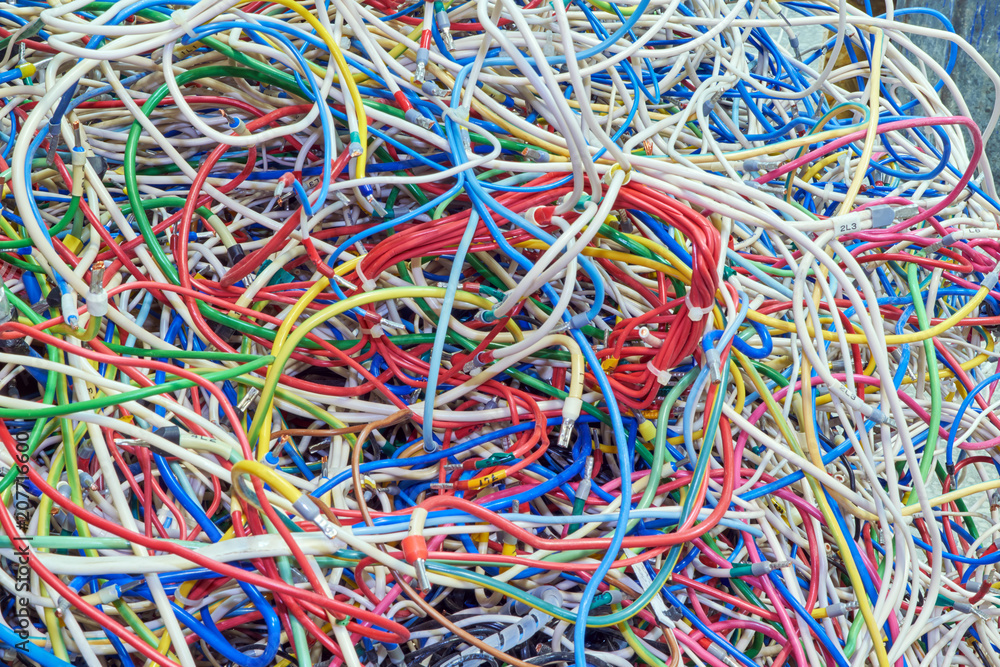The bunch of electric wires of different colors are very much ...