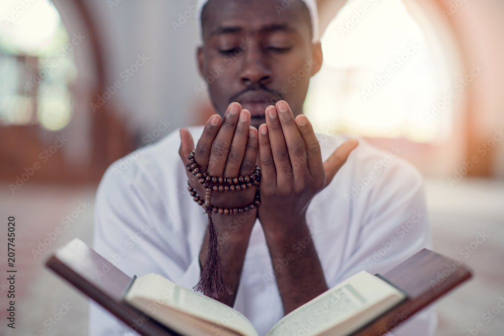 African Muslim Man Making Traditional Prayer To God While Wearing ...