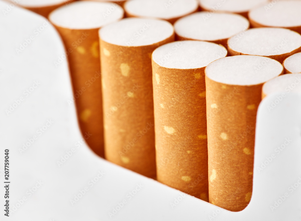 cigarettes in a pack close-up on a white background. Drug addiction ...