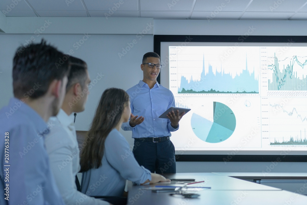 Businessman making presentation using screen of charts and graphs in ...