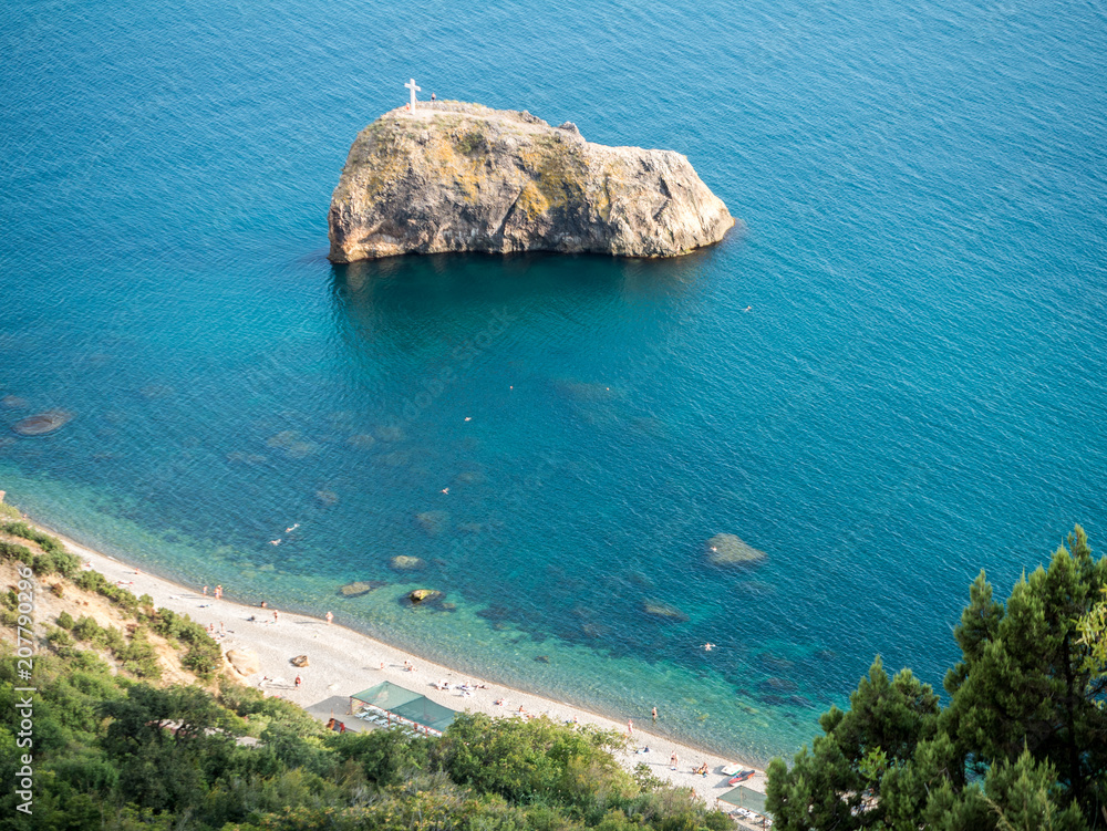 The top view and the beach. View from the high rocky shore. Azure-blue ...