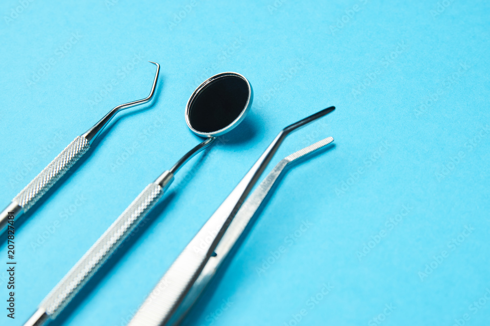 Professional Dentist tools on blue background with copy space. Dentist ...