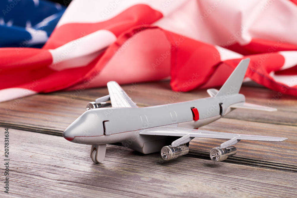 Grey toy air plane on wooden background. Plastic toy jet plane on table ...