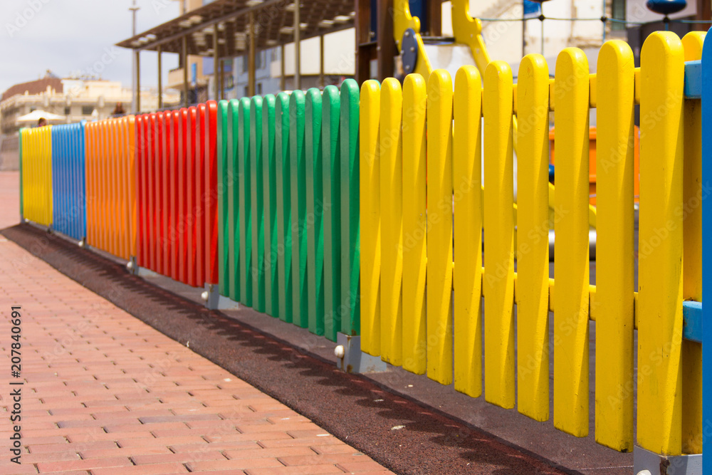 Colorful wooden fence of playground. Protection barrier for children in ...