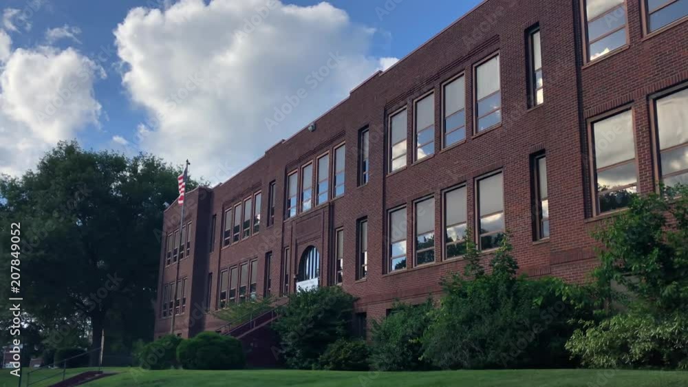 A daytime summer establishing shot of a typical red brick school ...