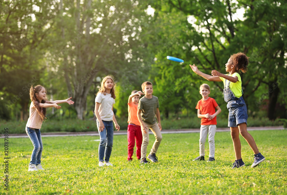 Cute little children playing with frisbee outdoors on sunny day Stock ...
