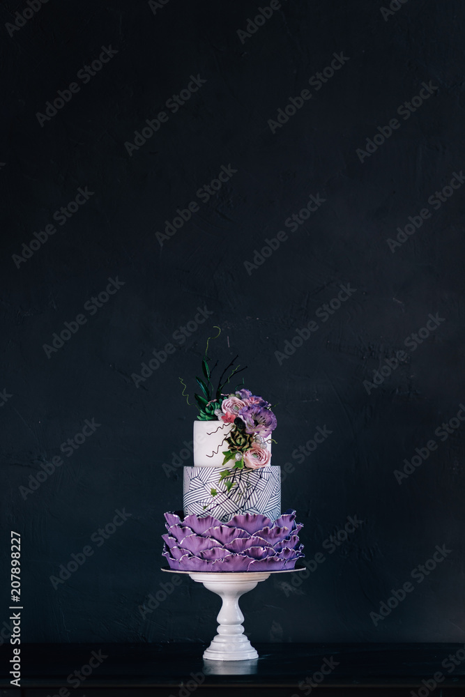 Purple happy birthday cake with beautiful flowers. Dozen of violet ...