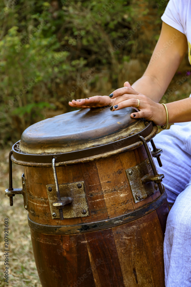 Photo & Art Print Woman percussionist hands playing a drum called ...