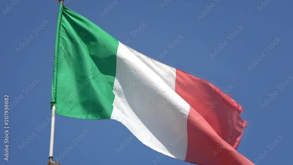 4K. National flag of Italy floating in the wind on a blue sky. Italian ...