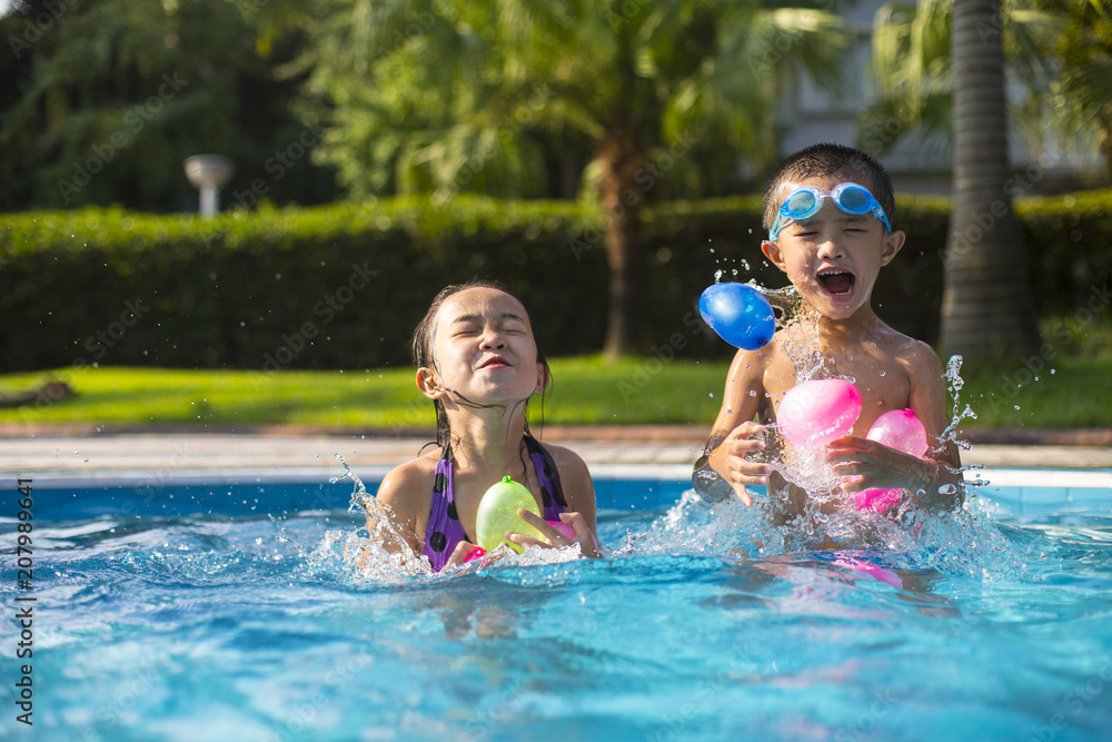 Two happy asian kids playing in the swimming pool Stock Photo | Adobe Stock