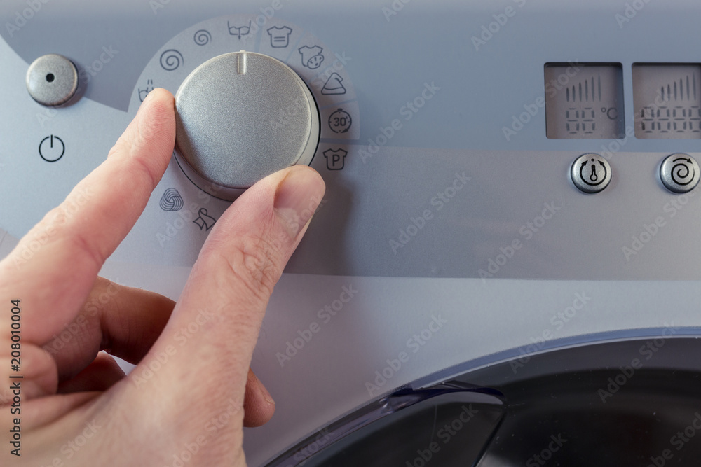 Hand Turning a Big Knob on a Washing Machine Dashboard Stock Photo ...