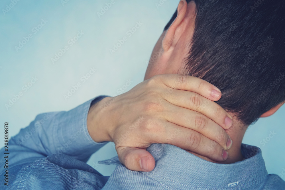 Close up of young man hand on his neck - neck pain concept. a fracture ...