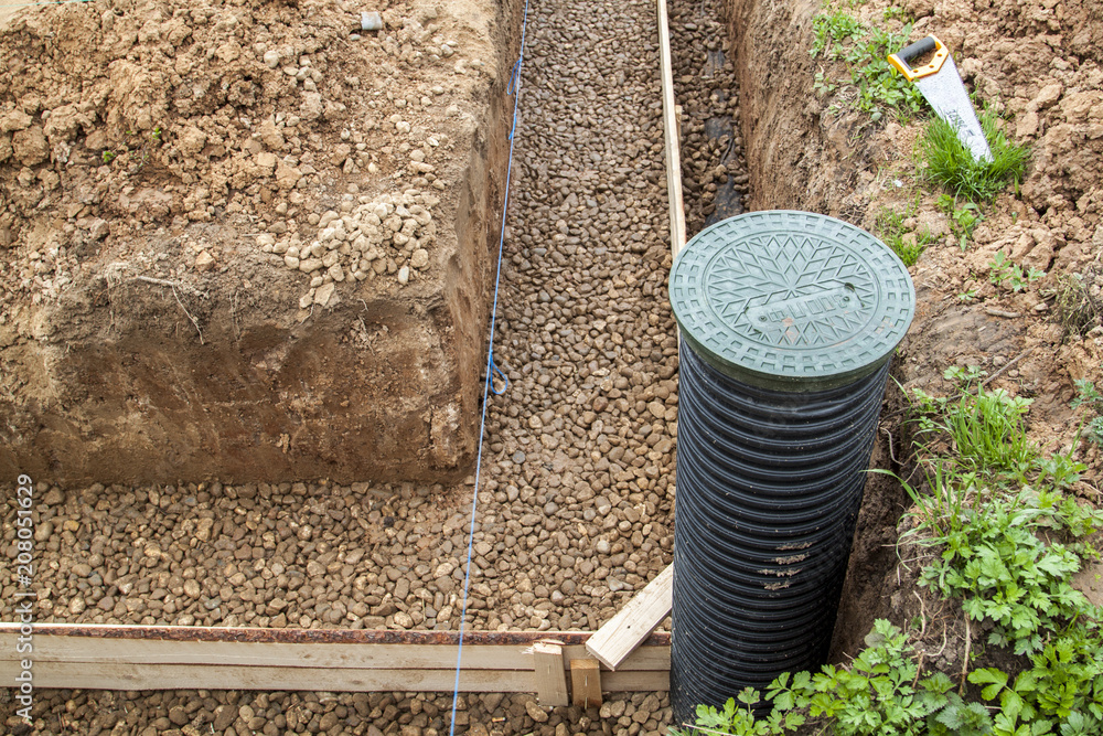 inspection well, drainage pipe and trench with formwork, which is ...