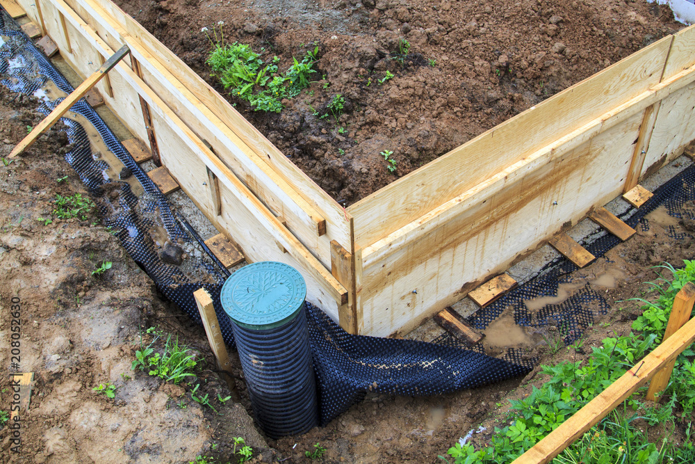 inspection well and trench with formwork. Preparation for pouring the ...