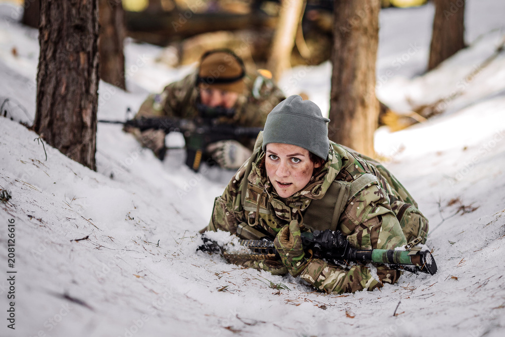 team of special forces weapons in cold forest. Winter warfare and ...
