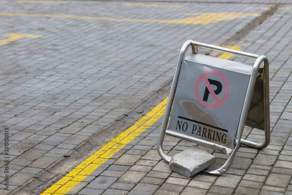 Dented sign, No Parking in the background paving slabs Stock Photo ...