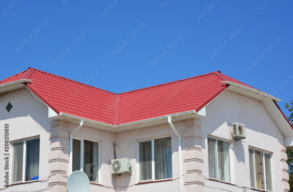 House red metal roofing with roof gutter. Stock Photo | Adobe Stock
