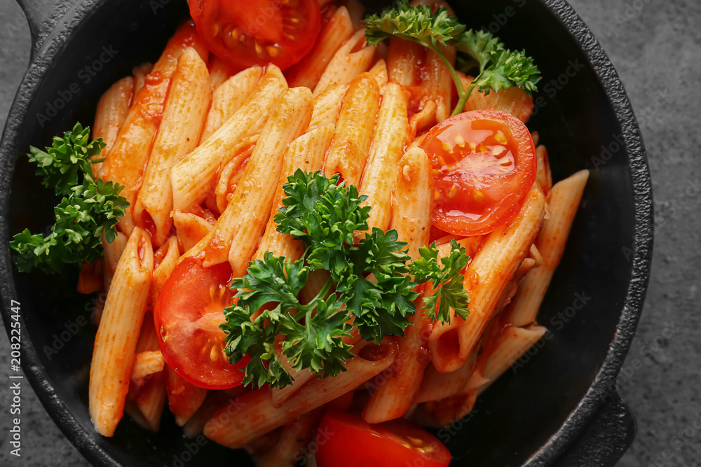 Pan with tasty pasta in tomato sauce on table, closeup Stock Photo ...