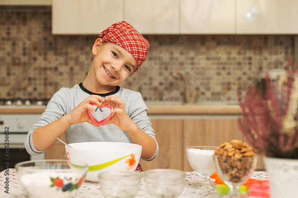 Cute boy shef showing his love while cooking holding a heart form for ...