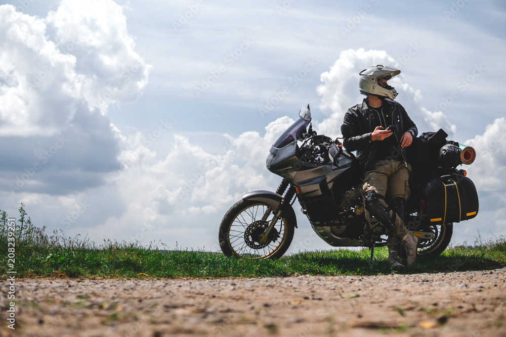 Rider Man and off road adventure motorcycles with side bags and ...