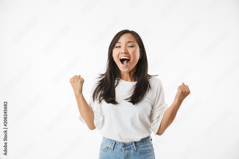 Excited pretty young asian woman showing winner gesture. Stock Photo ...