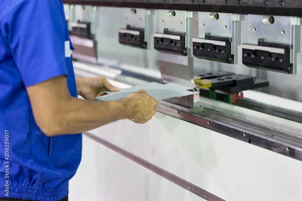 Operator working cut and bending metal sheet by high precision metal ...