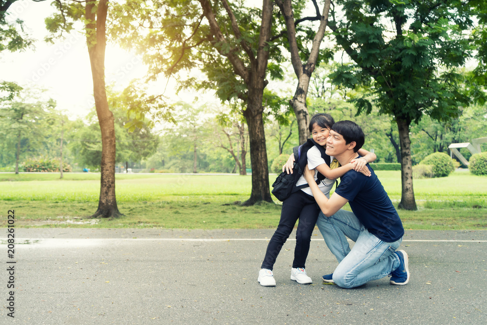 Kids student into father’s hands to hug her after back to school. Pupil ...