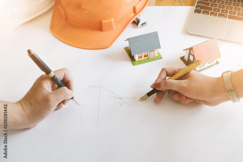 Architect team freehand drawing with pen on blueprint architectural in ...