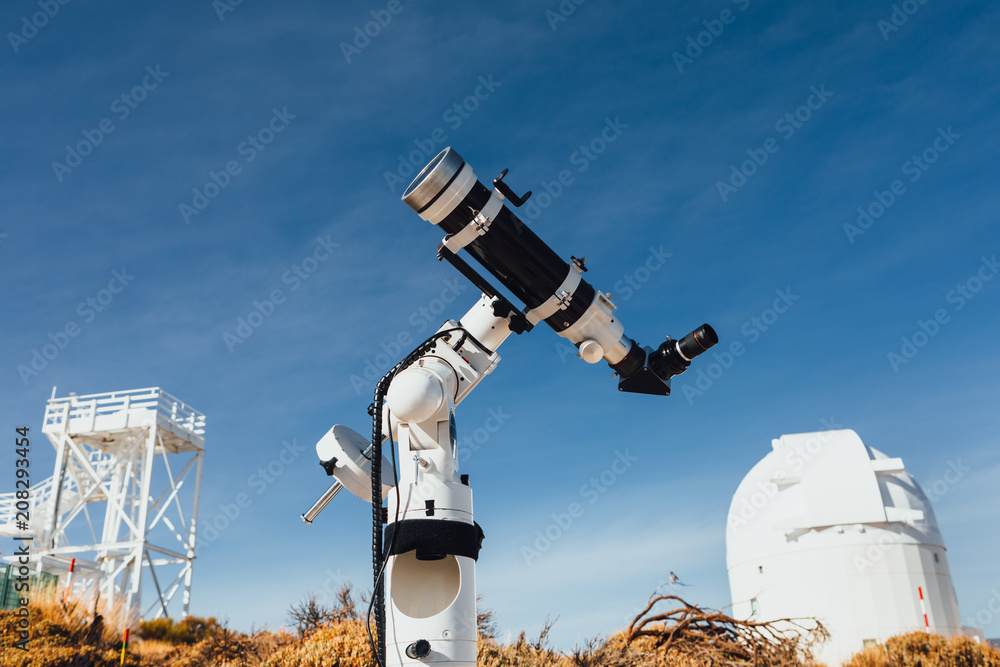 astronomical telescope tube, dome building and blue sky background ...